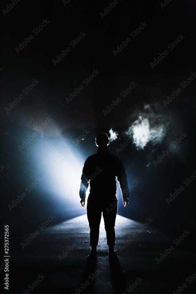 The man standing alone silhouette the darkness, abstract mysterious sci ...
