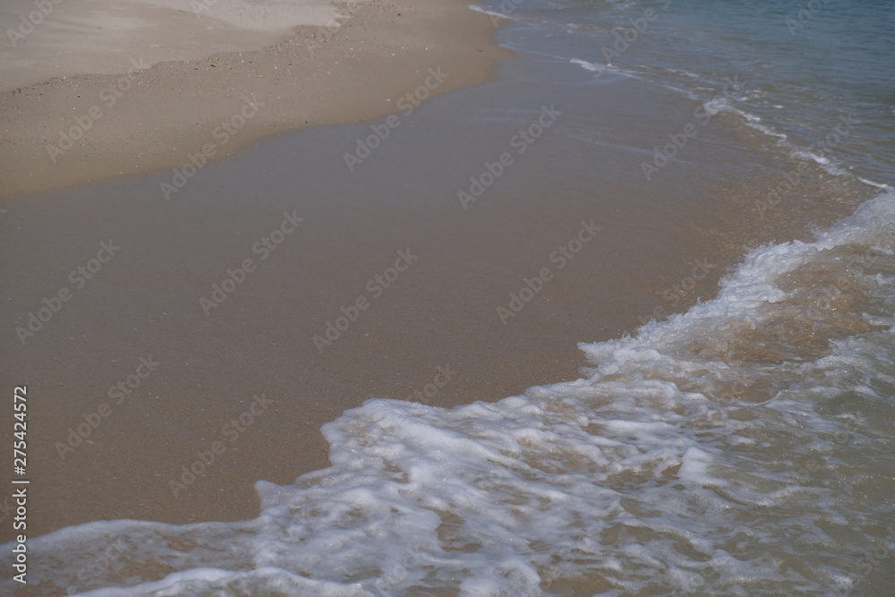 Beautiful background transparent surface wave, sand on clean seaside ...