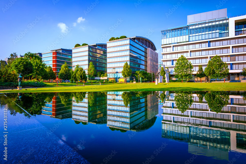 Urban landscape with modern office buildings, reflection on water ...