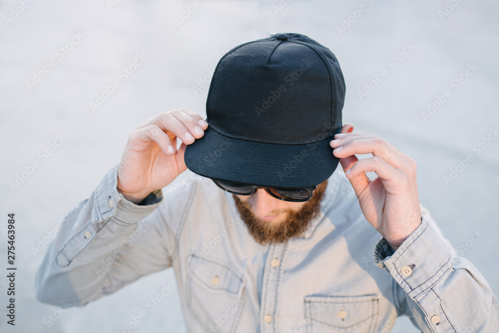 Hipster handsome male model with beard wearing black blank baseball cap ...