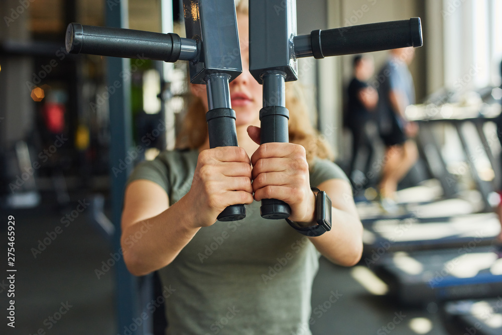 Girl in sportswear trains with gym equipment. Stock Photo | Adobe Stock