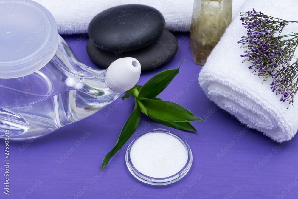 Spa purple background with Neti Pot, pile of Saline, rolled up White ...