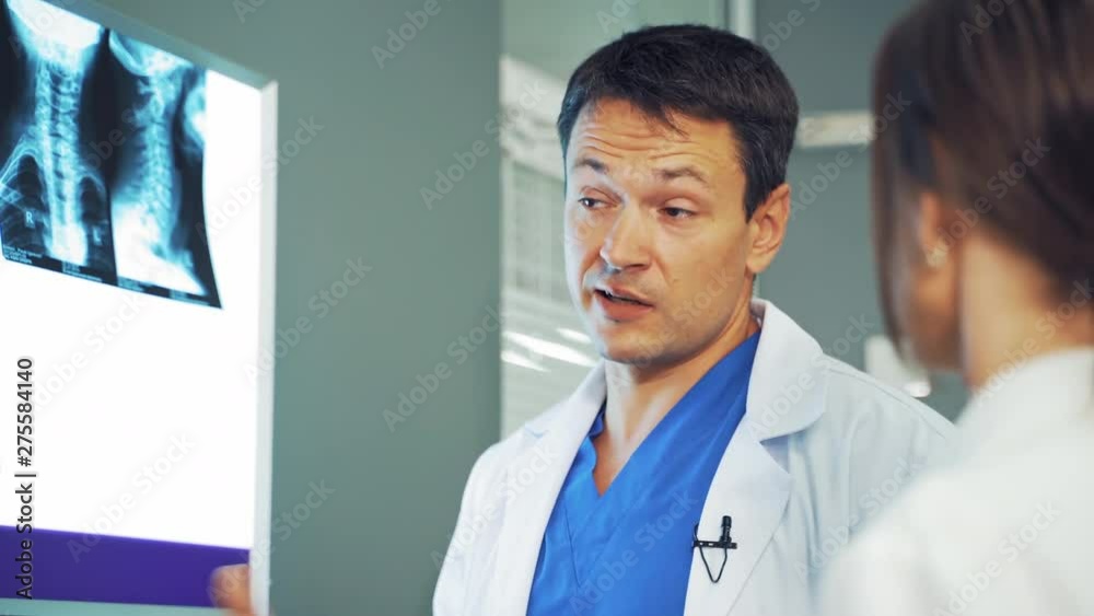 Doctor reviewing brain X rays. Doctor checking chest X ray film at ward ...