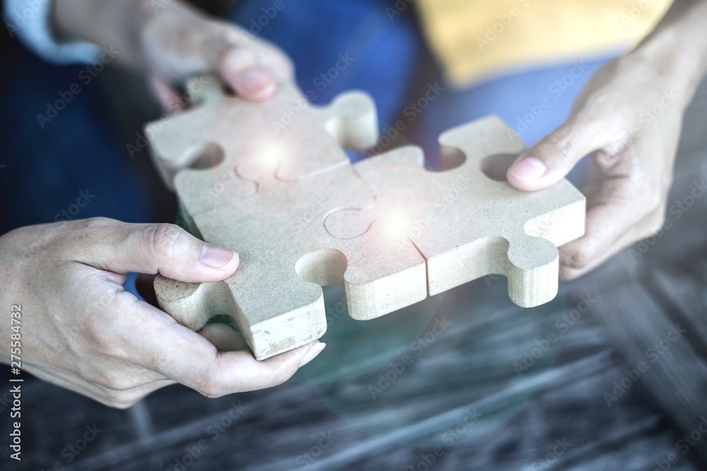 Closeup two hands trying to connect couple puzzle piece ,Symbol of ...