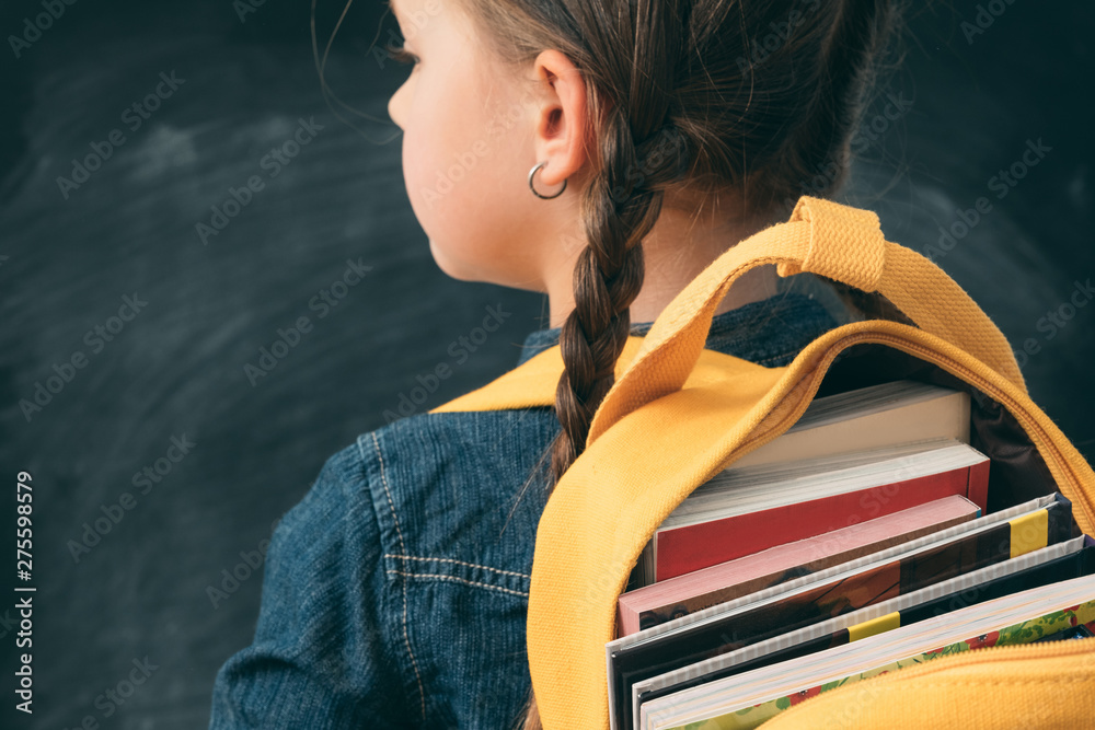 Back to school. Back view of young girl with open backpack fully ...