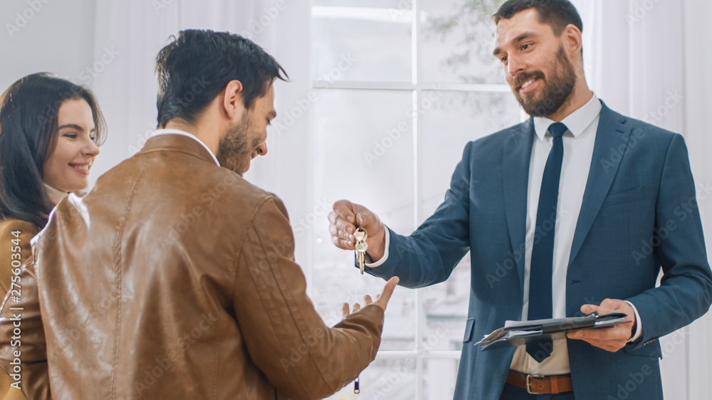 Professional Real Estate Agent in Bright New Apartment Gives Keys to a ...