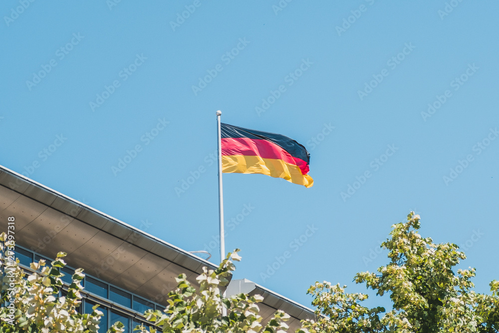 german flag on pole on building - national flag of Germany Stock Photo ...