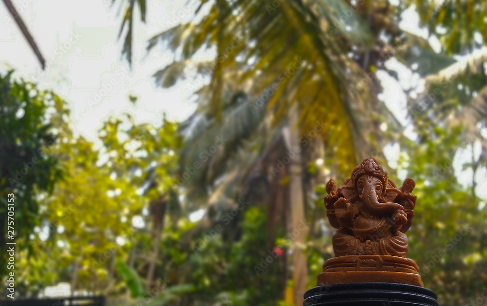 god ganesh statue background of greenery off focused Stock Photo ...