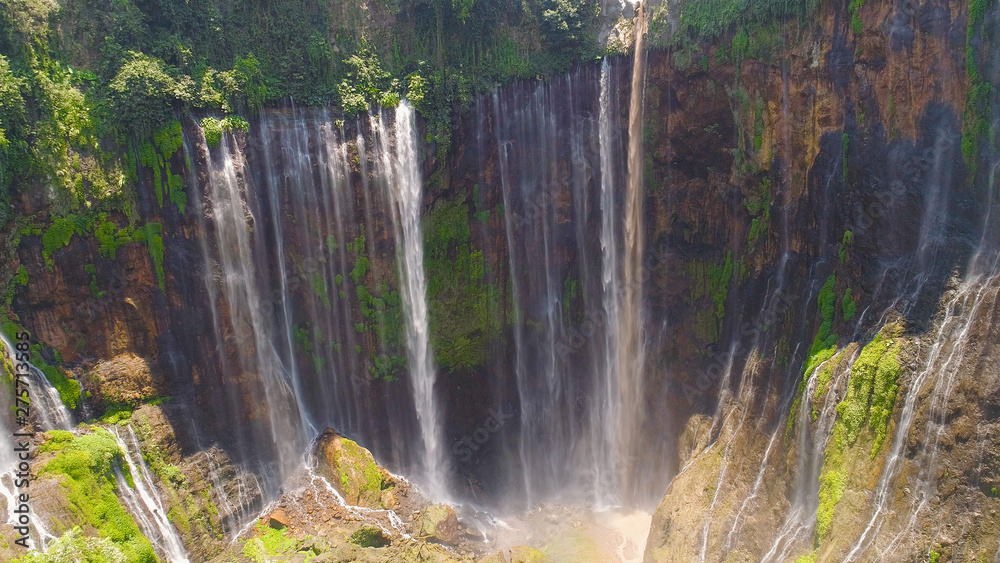 beautiful waterfall Coban Sewu in tropical forest, Java Indonesia ...