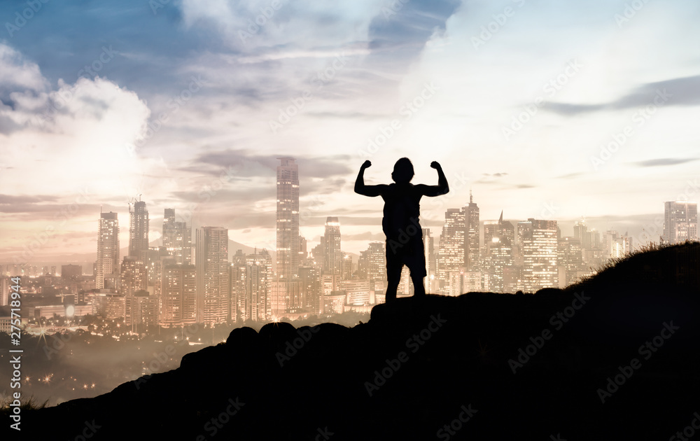 Strong man on top a mountain facing the city. Motivational, victory ...
