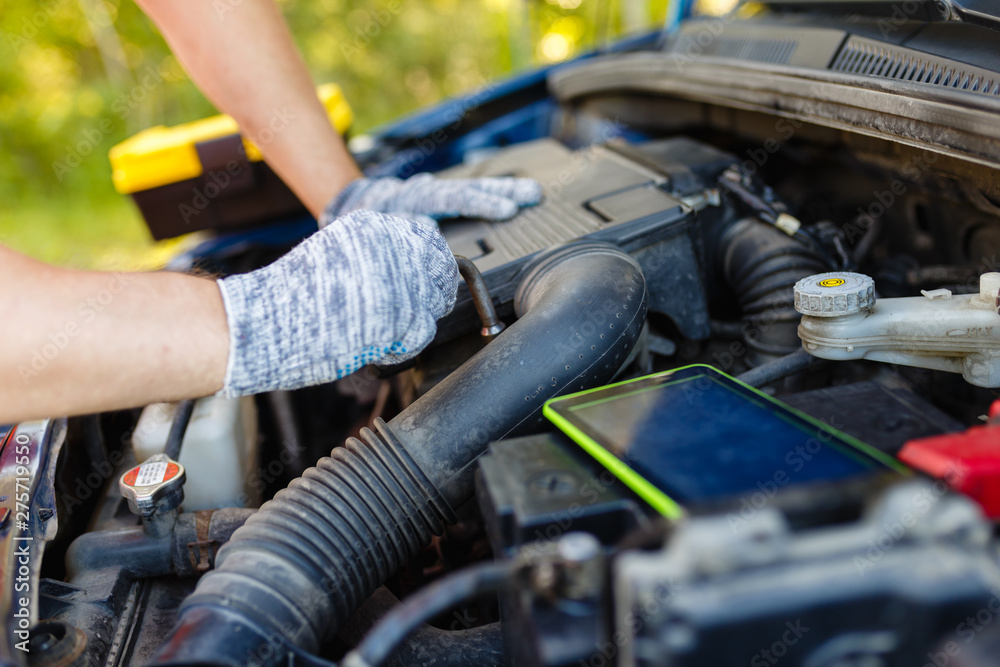 Hands of mechanic repairing the engine of the special keys (wrenches ...