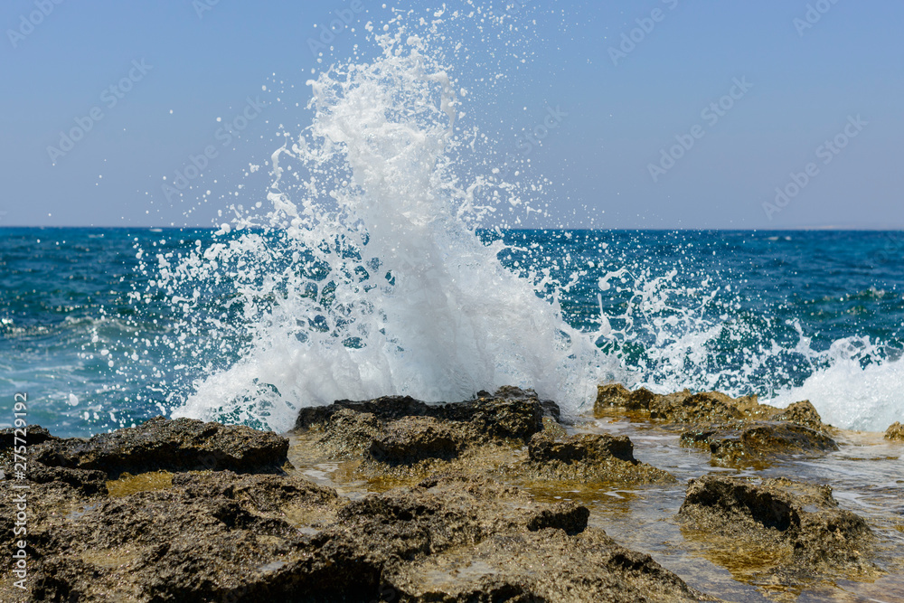 splashing waves crashing against a stone beach Stock Photo | Adobe Stock