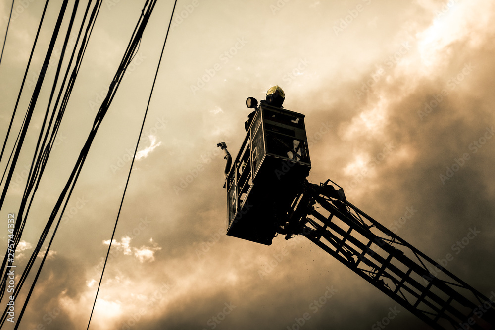 Firefighters in action. The firefighter team is lifting the high-rise ...
