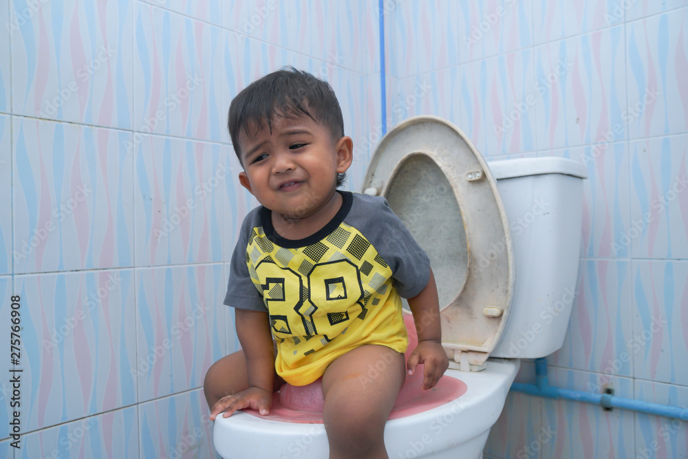Cute little asian boy sitting on the toilet,Baby constipation Concept ...