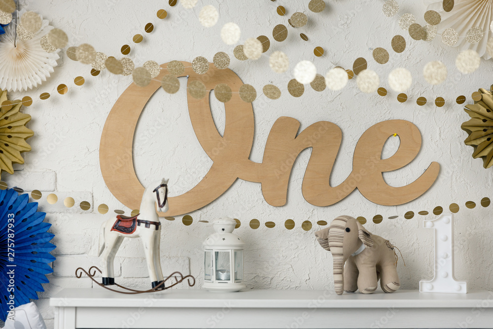 Big wooden figure one whit gold garlands. Birthday decorations with ...