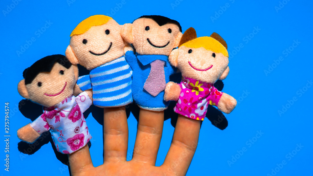 Puppet theater. Hand wearing finger family members puppets: mum, dad ...