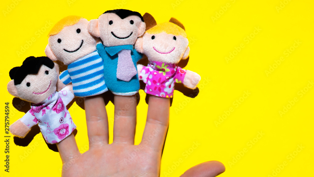 Puppet theater. Hand wearing finger family members puppets: mum, dad ...