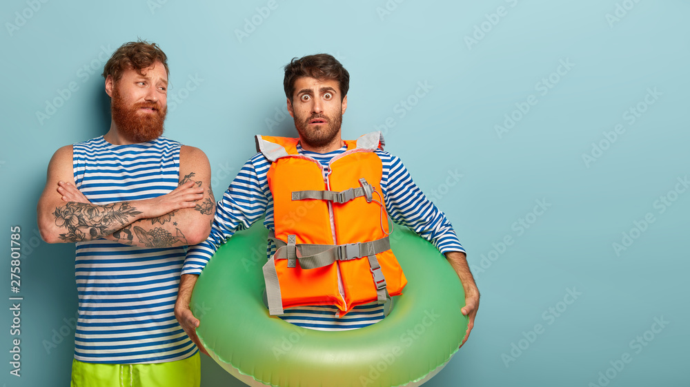 Swimming activities and summer vacation concept. Embarrassed young male ...