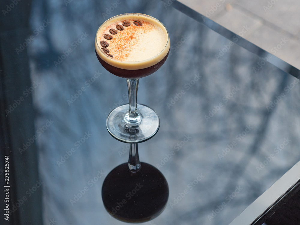 Coffee cocktail on a grey table in a transparent glass with coffee ...