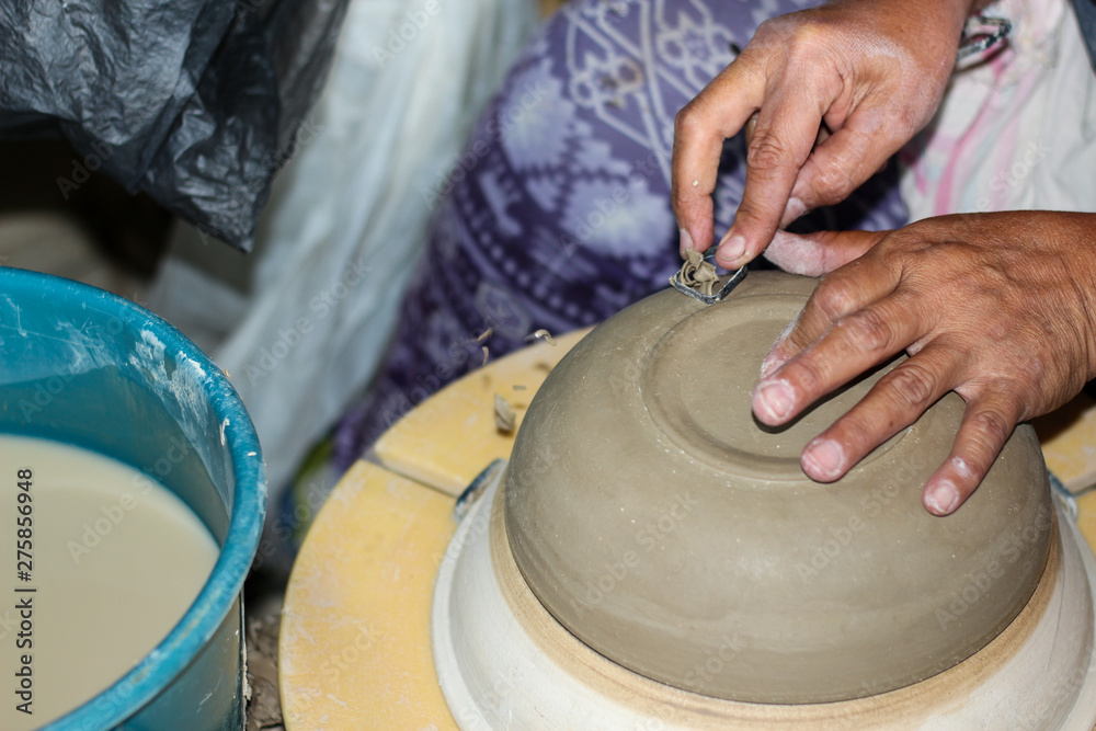 hands of a potter, creating an bowl on the circle, Pottery polishing ...