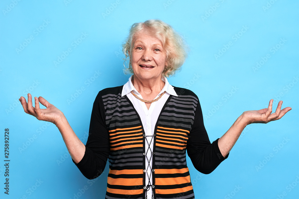 old stylish blonde woman with clueless confused expression standing ...