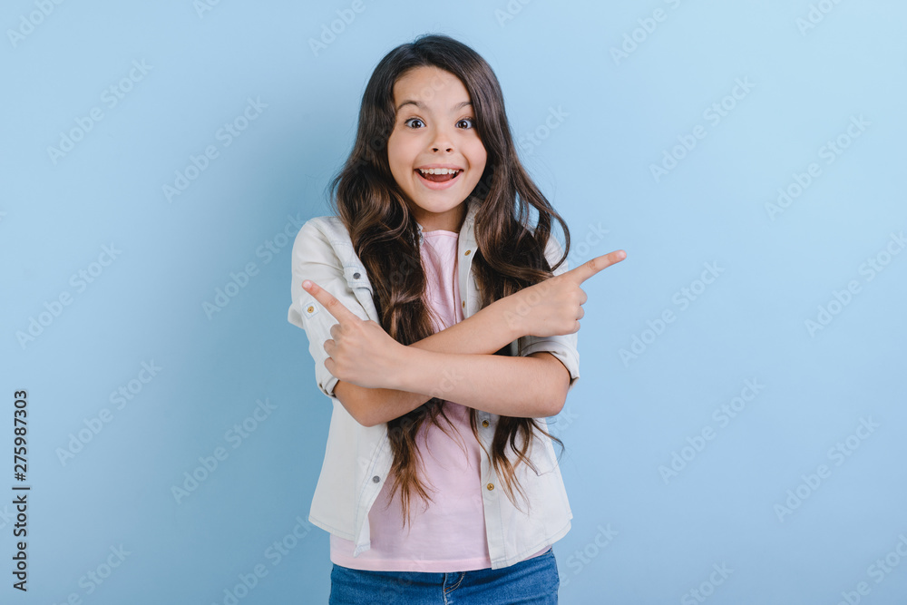Excited Young Girl Pointing Her Index Finger Right And Left With