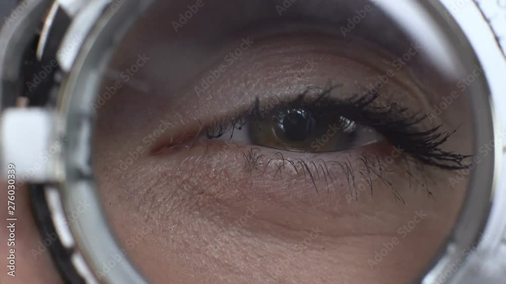 Female eye looking through optical trial frame closeup, vision ...