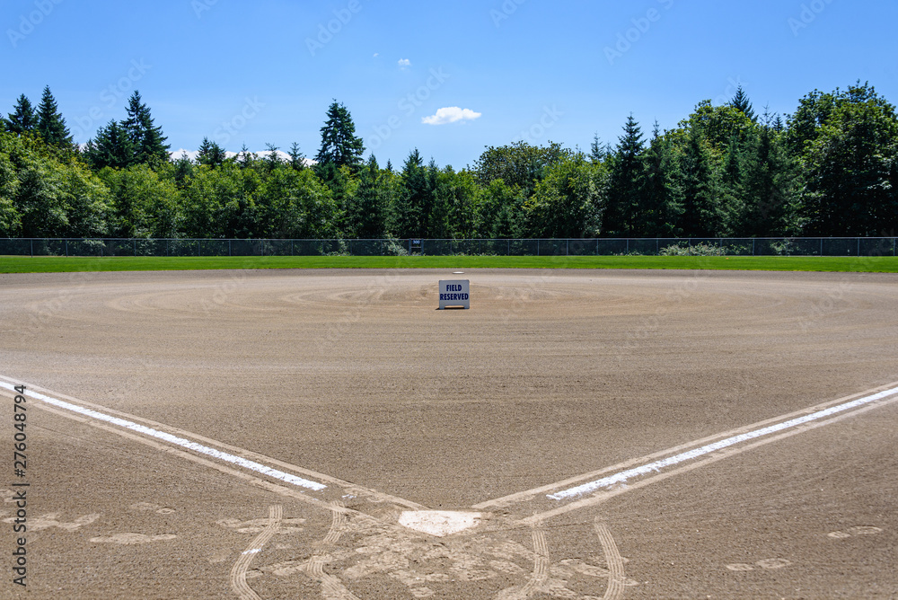 Freshly groomed baseball field with Field Reserved sign, empty baseball ...
