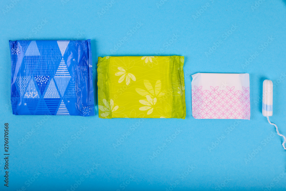 Menstrual pads on a blue background. Photos | Adobe Stock