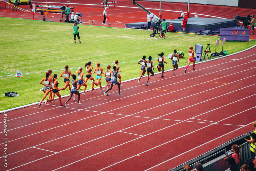 Female track and field race at athletics stadium. Professional female ...