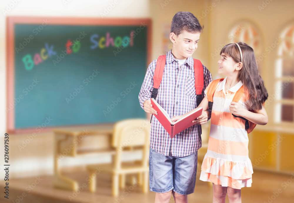 School kids in the classroom with back to school message written on the ...