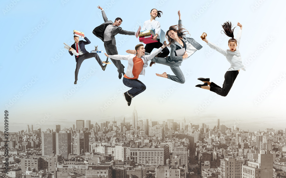 Happy office workers jumping and dancing in casual clothes or suit with ...