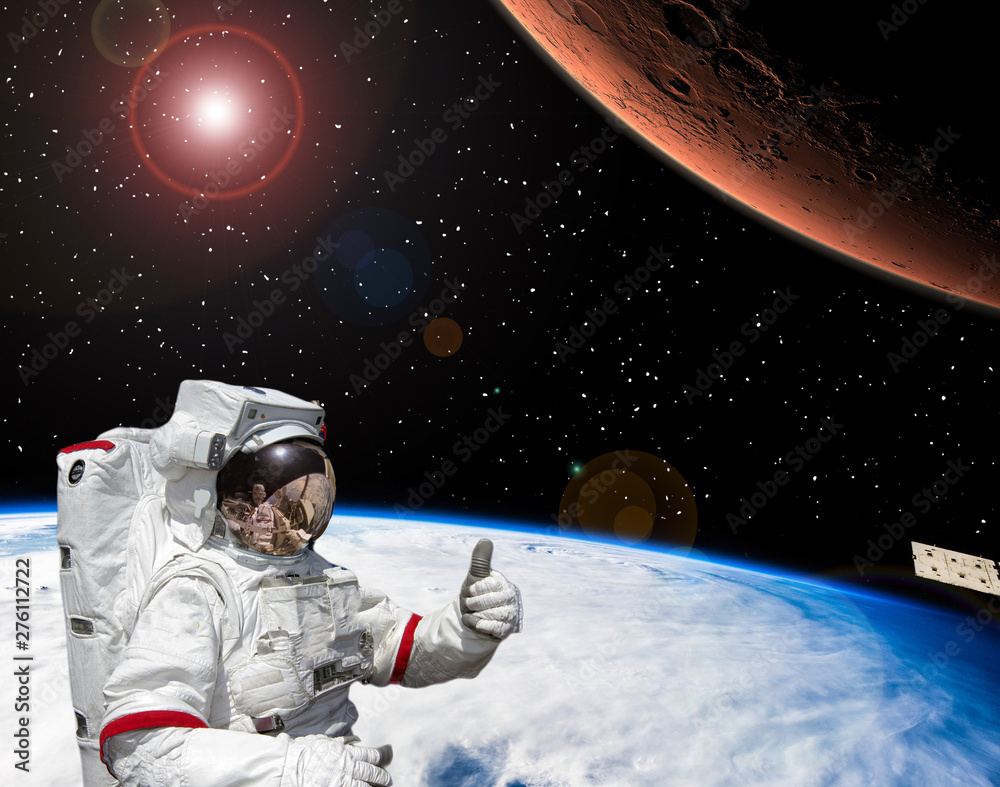 Astronaut shows the thumbs-up about flying to Mars. Mars. The elements ...