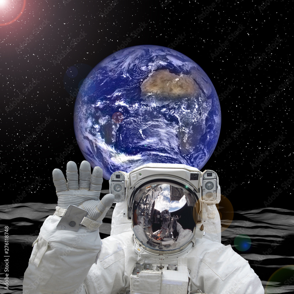 Astronaut posing on alien land. Earth on the backdrop. The elements of ...