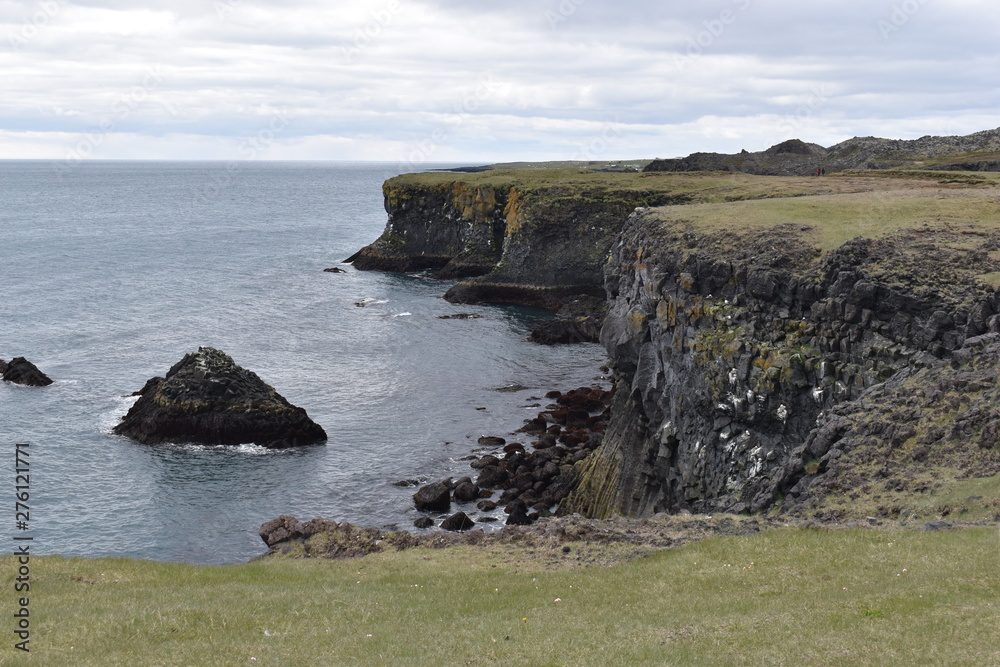 Hiking trail from Anarstapi to Hellnar with the raw ocean und big rocks and mountains in the ...