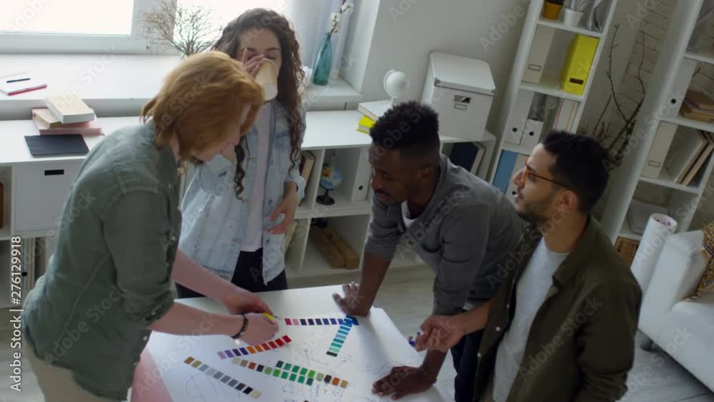 High-angle shot of four multicultural millennial graphic designers ...