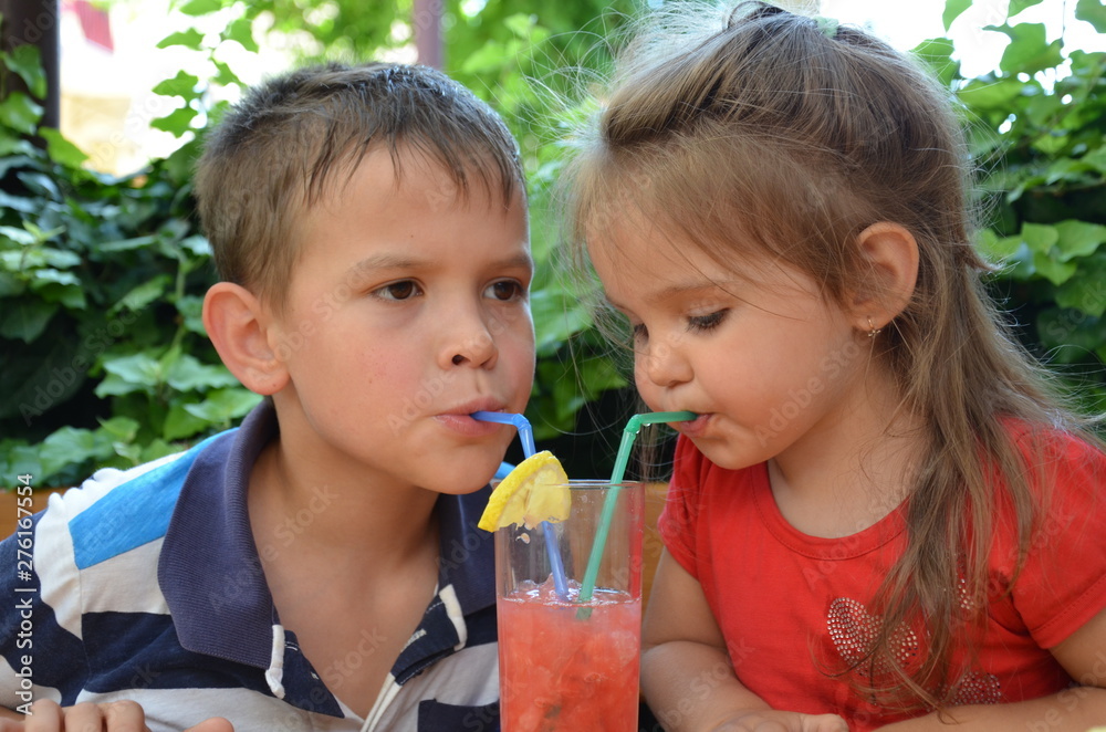 smiling boy girl drinking two straws. Boy and girl sharing a smoothie ...