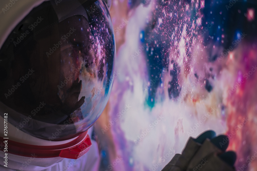 Astronaut looking deep space, galaxy and planets from the window of his ...