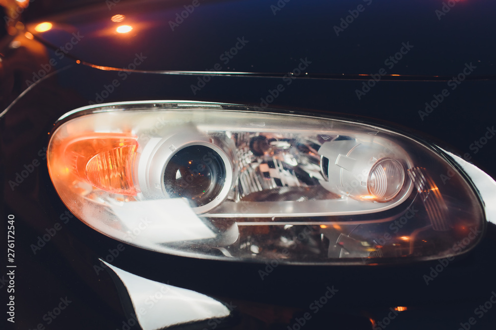 Close up of headlight detail of modern luxury car with projector lens ...