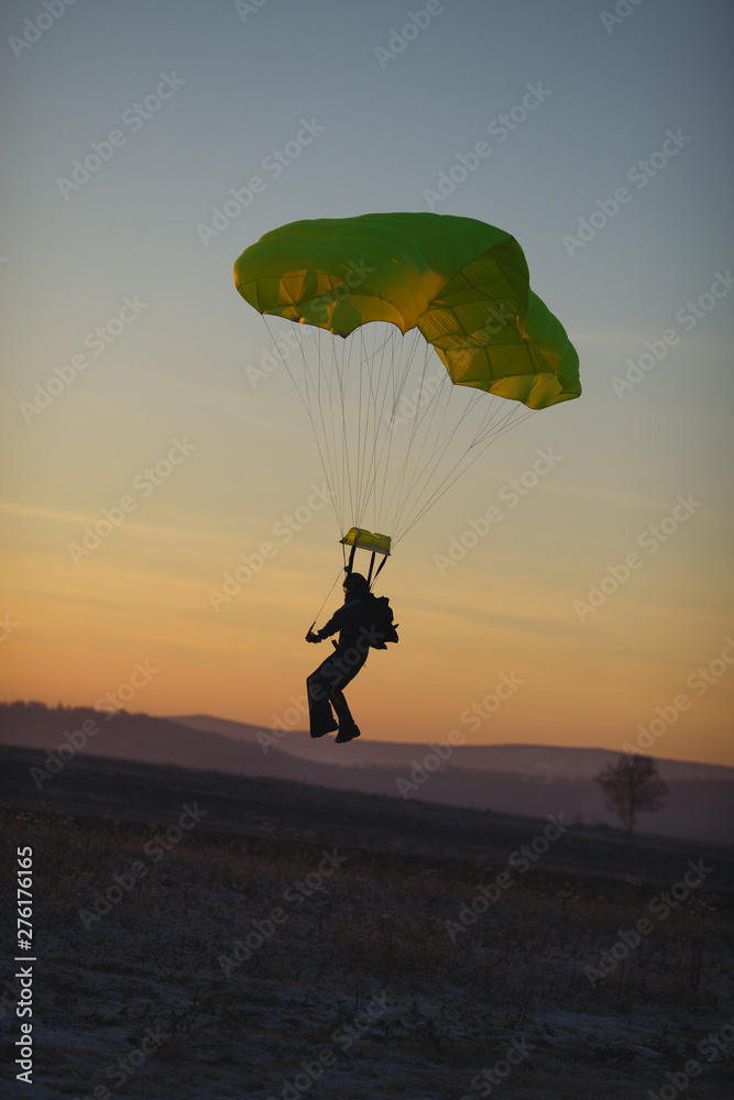 Landing skydiver under the reserve parachute after the malfunction of ...