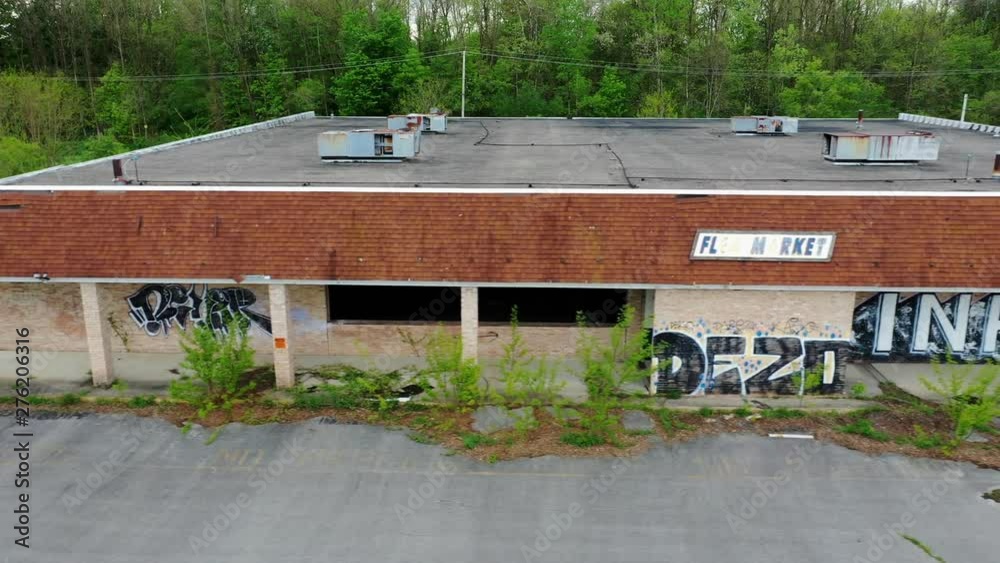 Aerial Panning view of an abandoned strip mall near the coast of ...