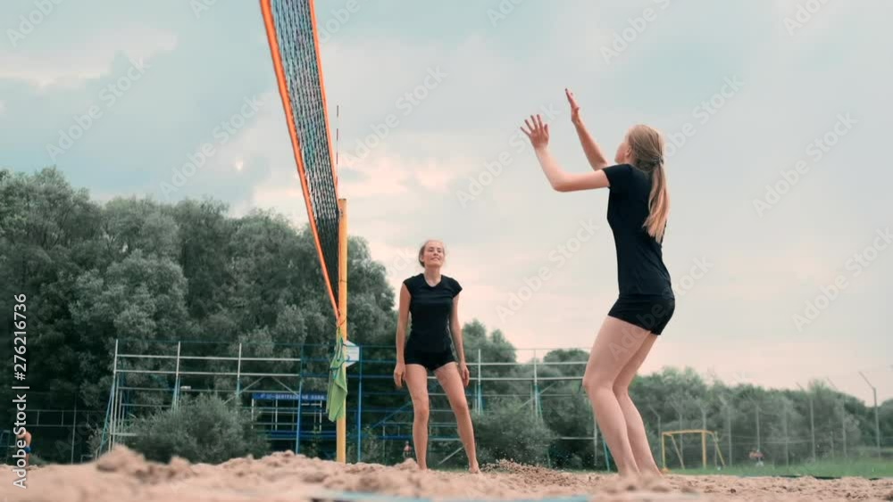 Four girls playing volleyball on the beach. Beach volleyball, net ...
