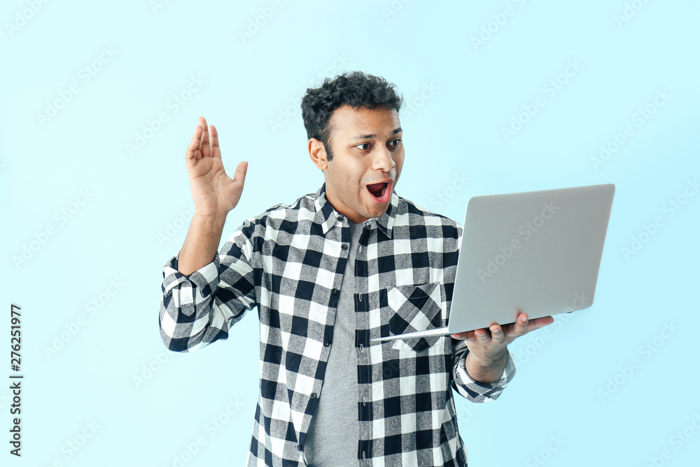 Happy man with laptop on color background Stock Photo | Adobe Stock