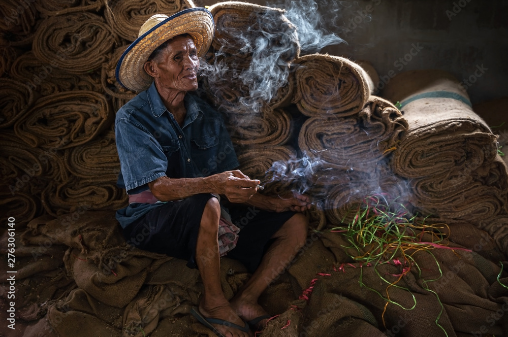 Old man smoking cigarette and the smoke released from the mouth, Bad ...