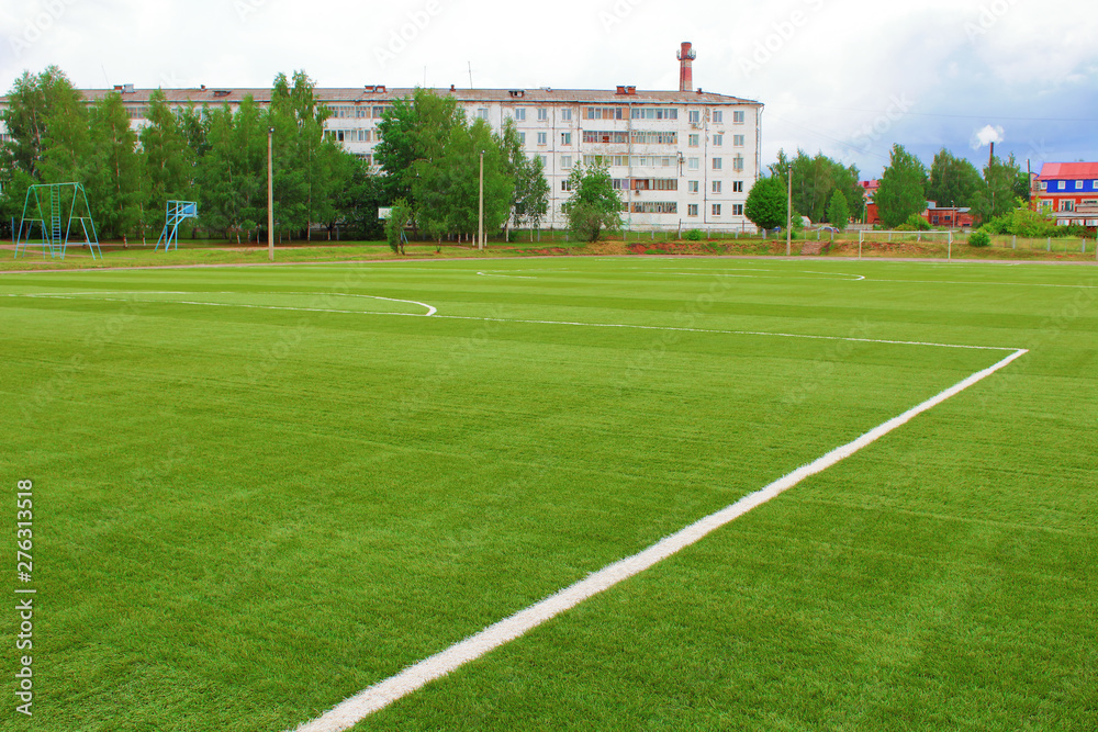New artificial football field. School stadium in the city. Background ...