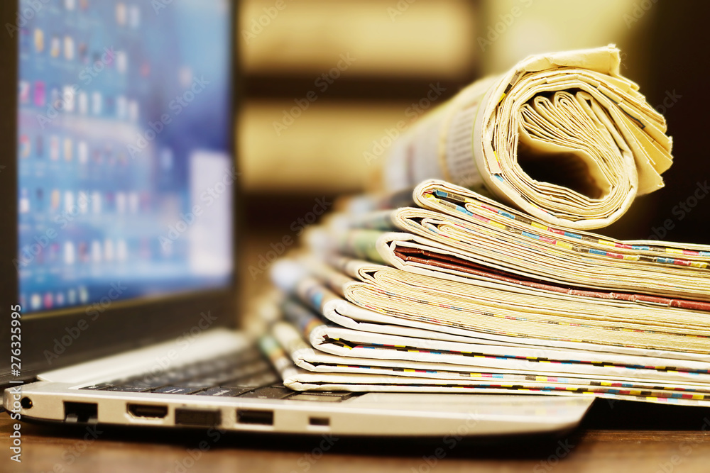 Newspapers and Laptop. Different Concepts for News - Social Network or ...