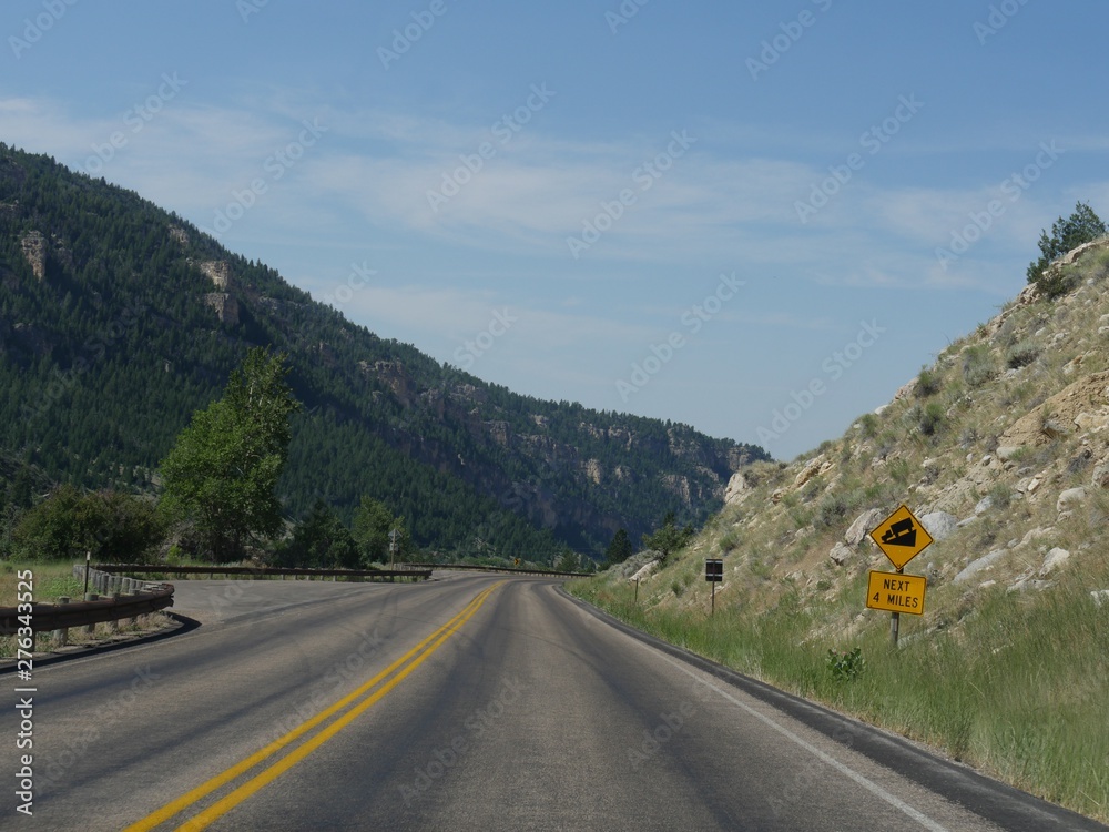 Scenic drive with roadside warning of a steep slope in the next four ...