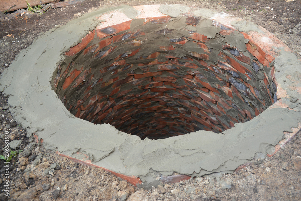 Installing brick septic tank. Sewer brick tank hole installation on ...