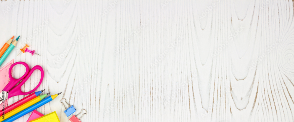 School supplies corner border banner. Top view on a white wood ...