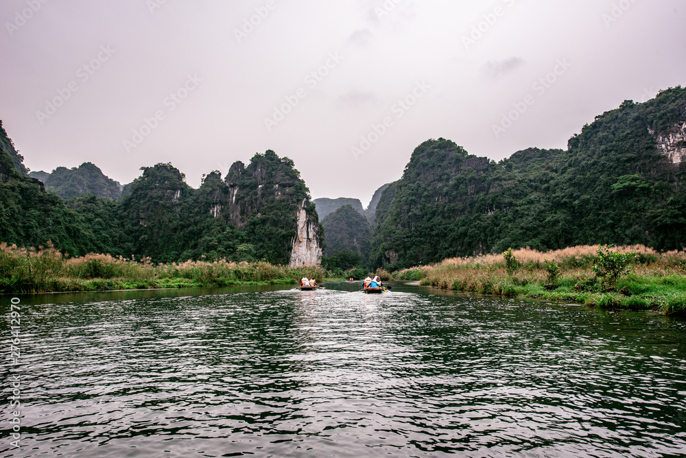 Boat cave tour in Trang An Scenic Landscape formed by karst towers and ...